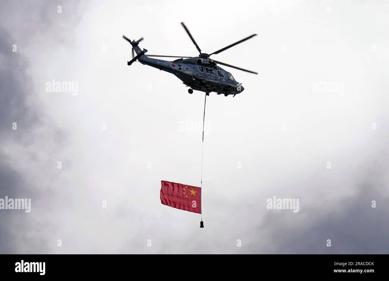 A helicopter carrying Chinese national flag flies over the venue during ...