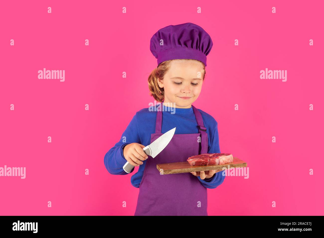 Child cook hold cutting board with meat beef steak and knife. Cooking ...