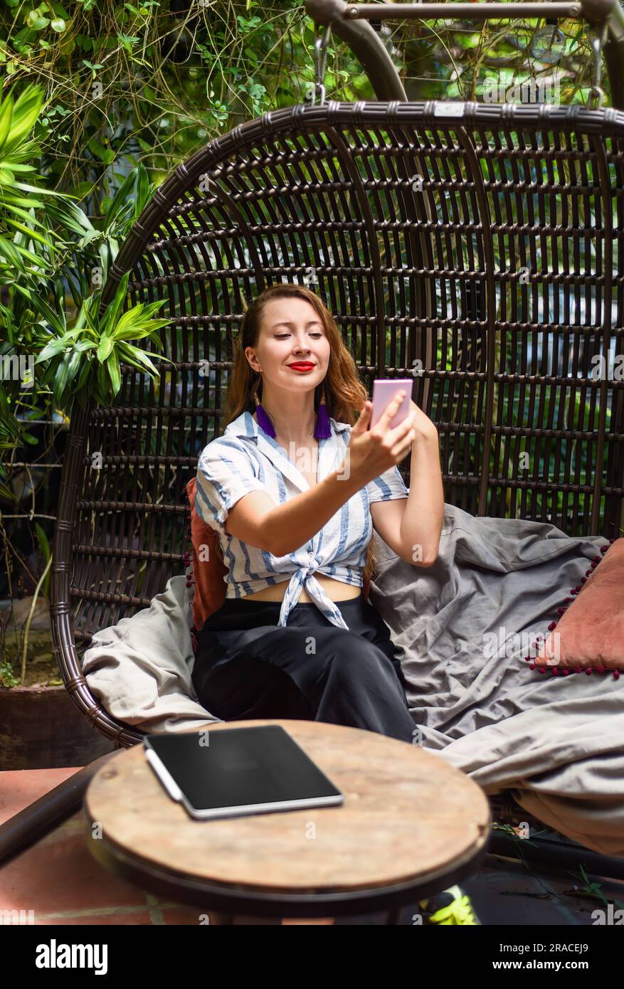 Young beautiful woman looking at pocket mirror prepearing herself for ...