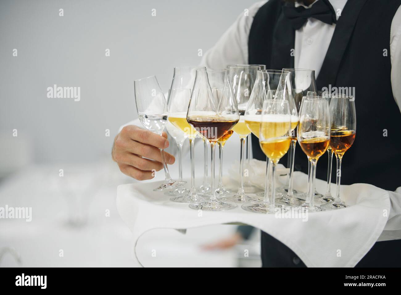 Various alcoholic beverages in different glass on tray holding wine ...