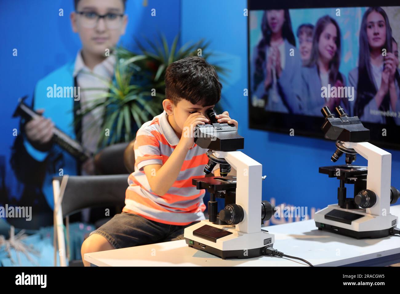 Baghdad, Iraq. 2nd July, 2023. A child looks into a microscope during ...