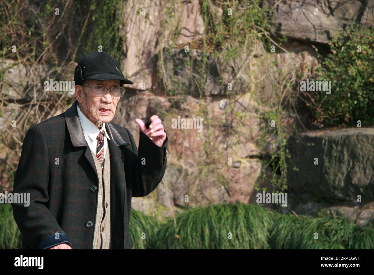 Well dressed Man in front of Rock Pond and Fountain on Hefang Jie in ...