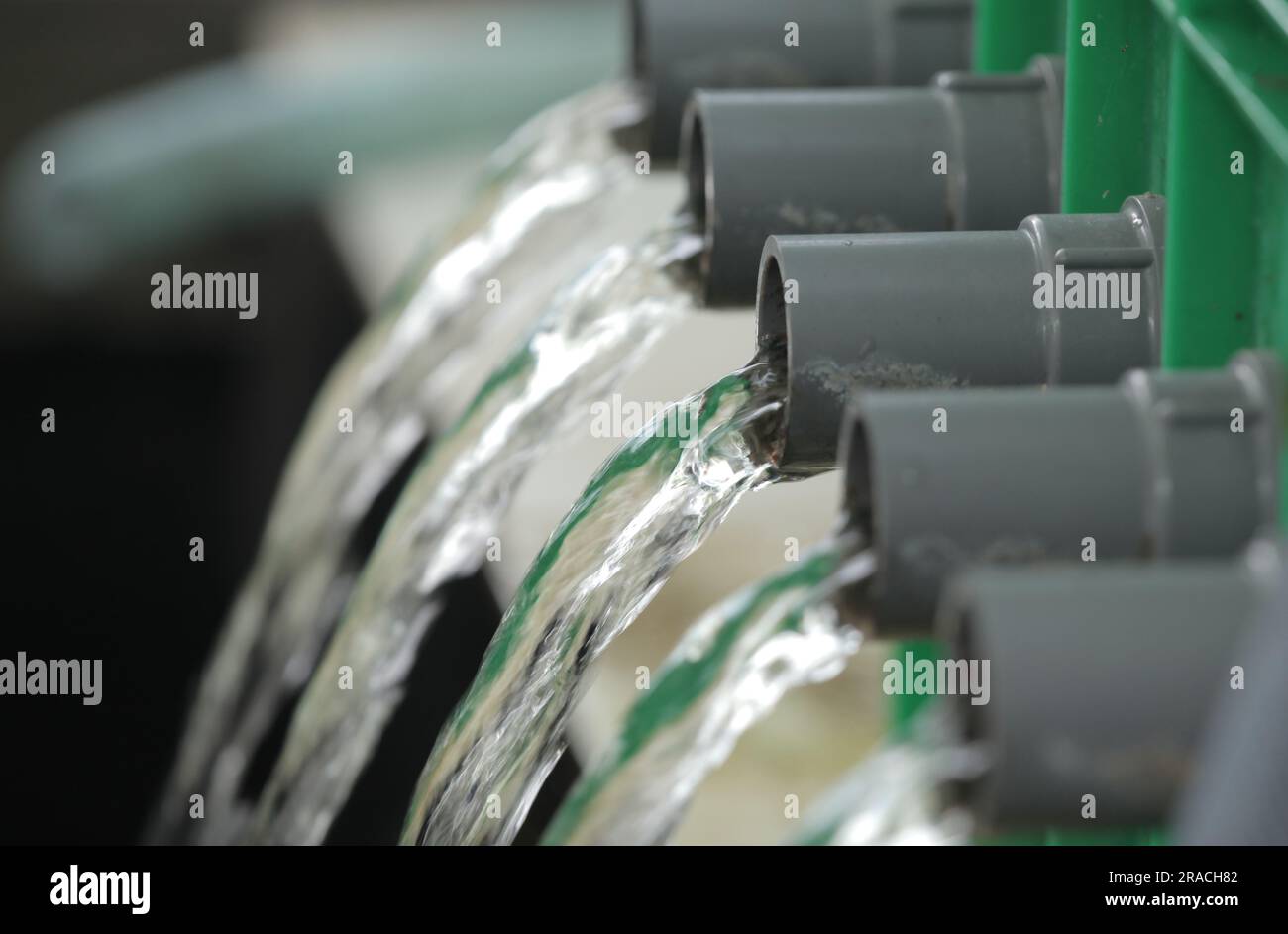 Water flows from a pipe. Clean water flows in a pipe after being ...