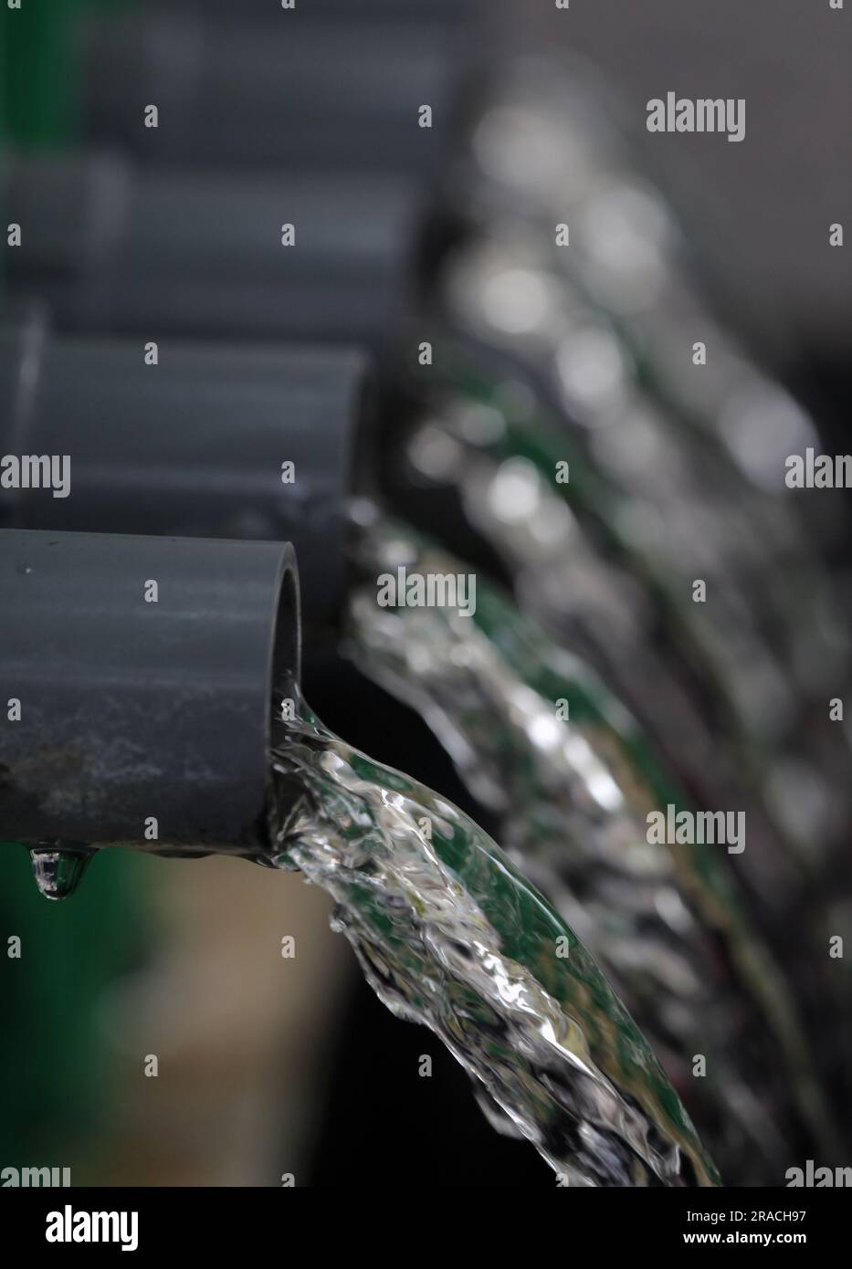 Water flows from a pipe. Clean water flows in a pipe after being ...