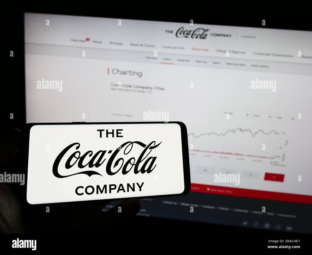 Person holding mobile phone with logo of American beverage business The ...