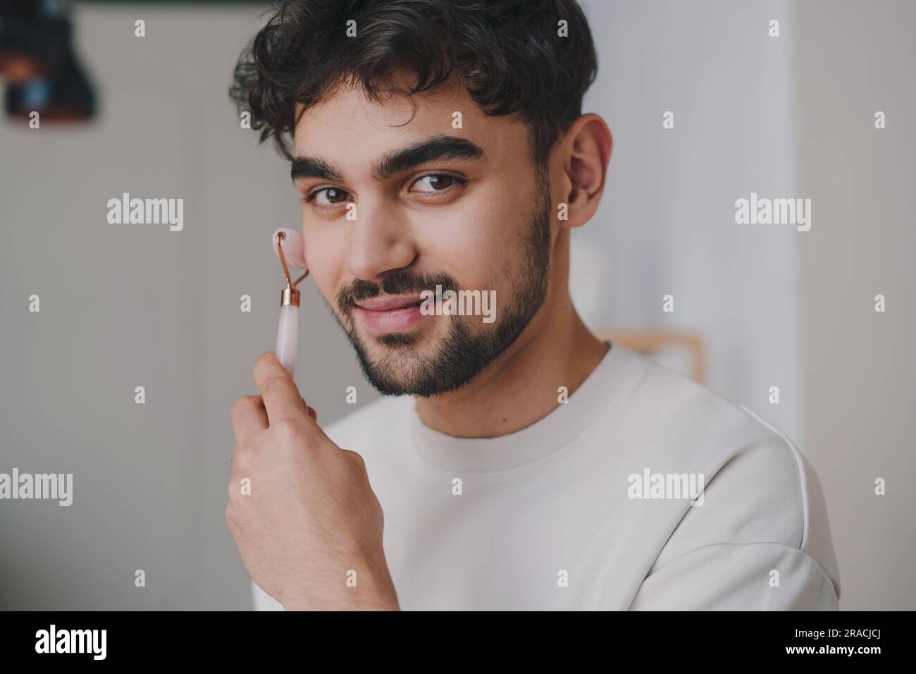 Positive young man smoking cigarette at home Stock Photo - Alamy