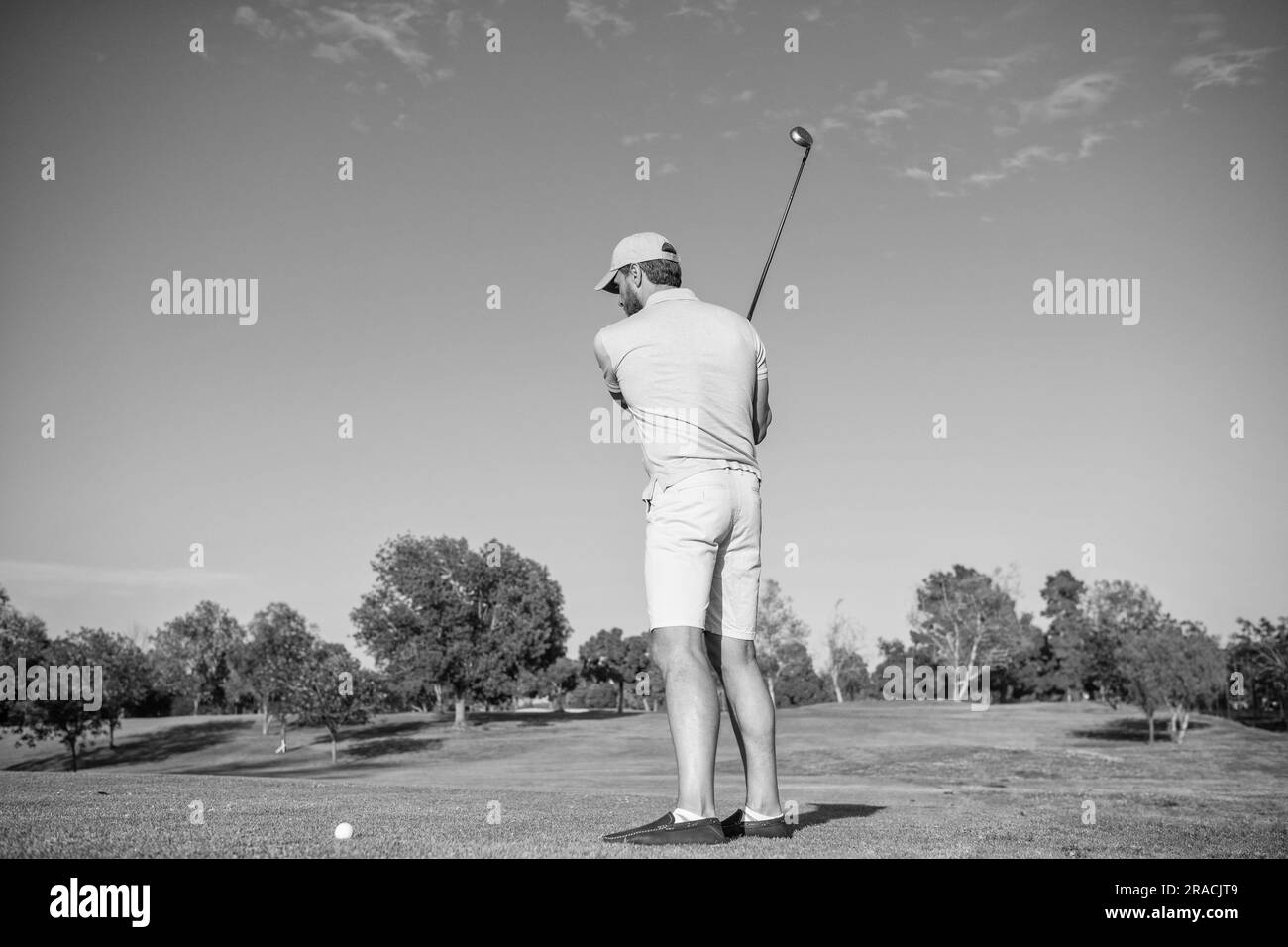 male golf player on professional golf course. portrait of golfer in cap ...