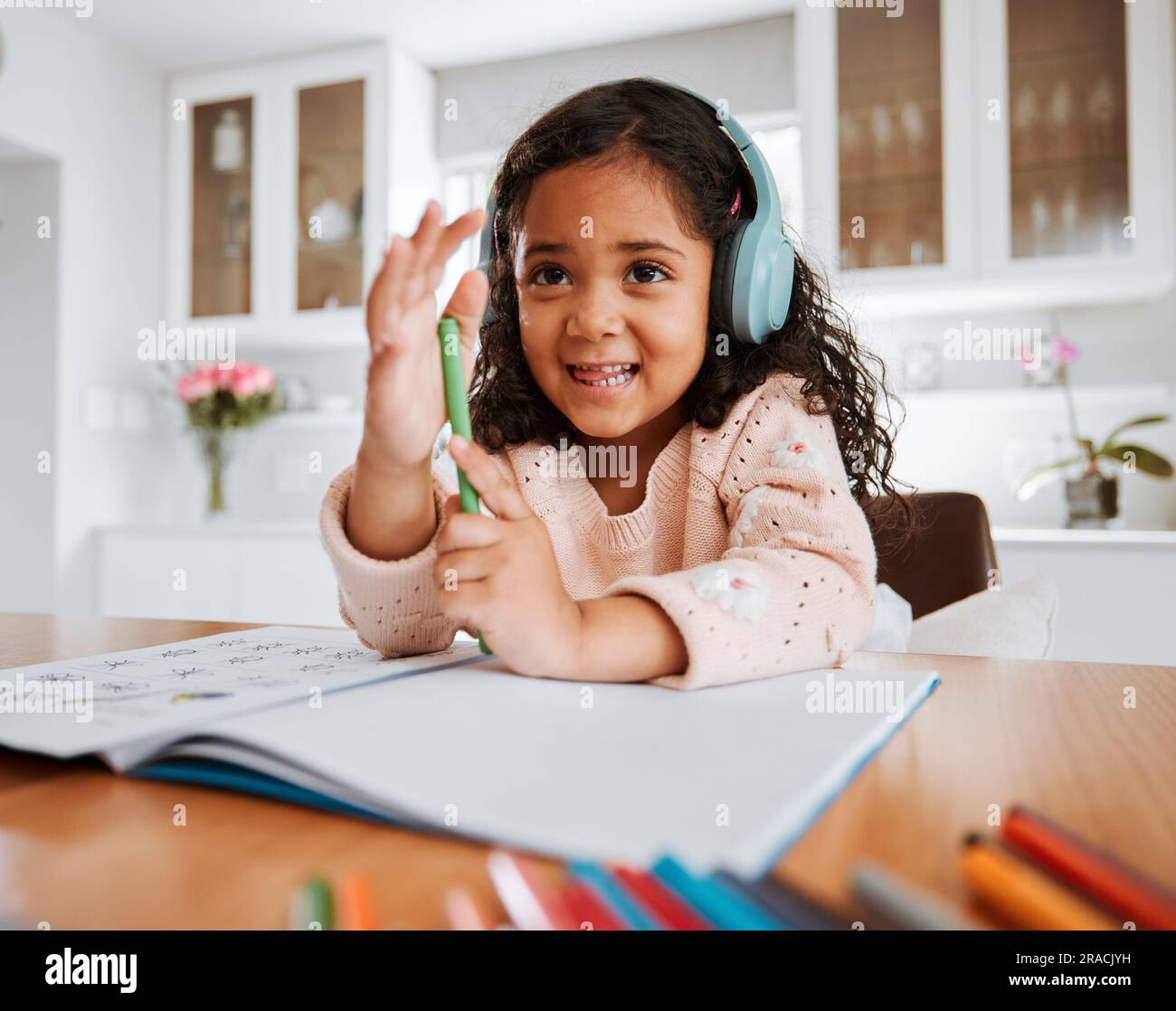 Girl child, home and drawing with headphones, notebook or smile for ...