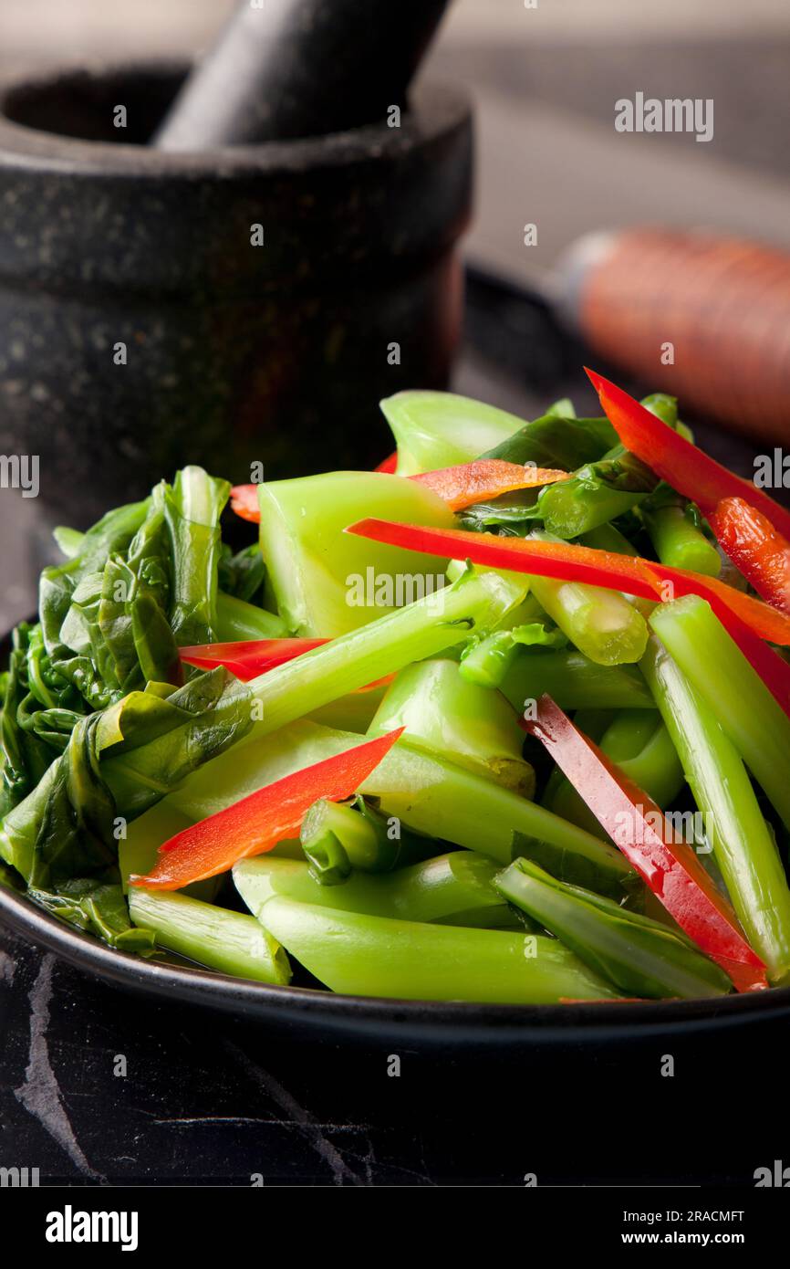 Blanched gailan with red capsicum garnish Stock Photo - Alamy