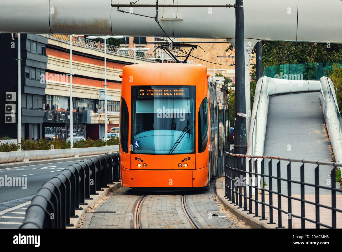 Modern orange tram on the street of Alicante, Spain Stock Photo - Alamy
