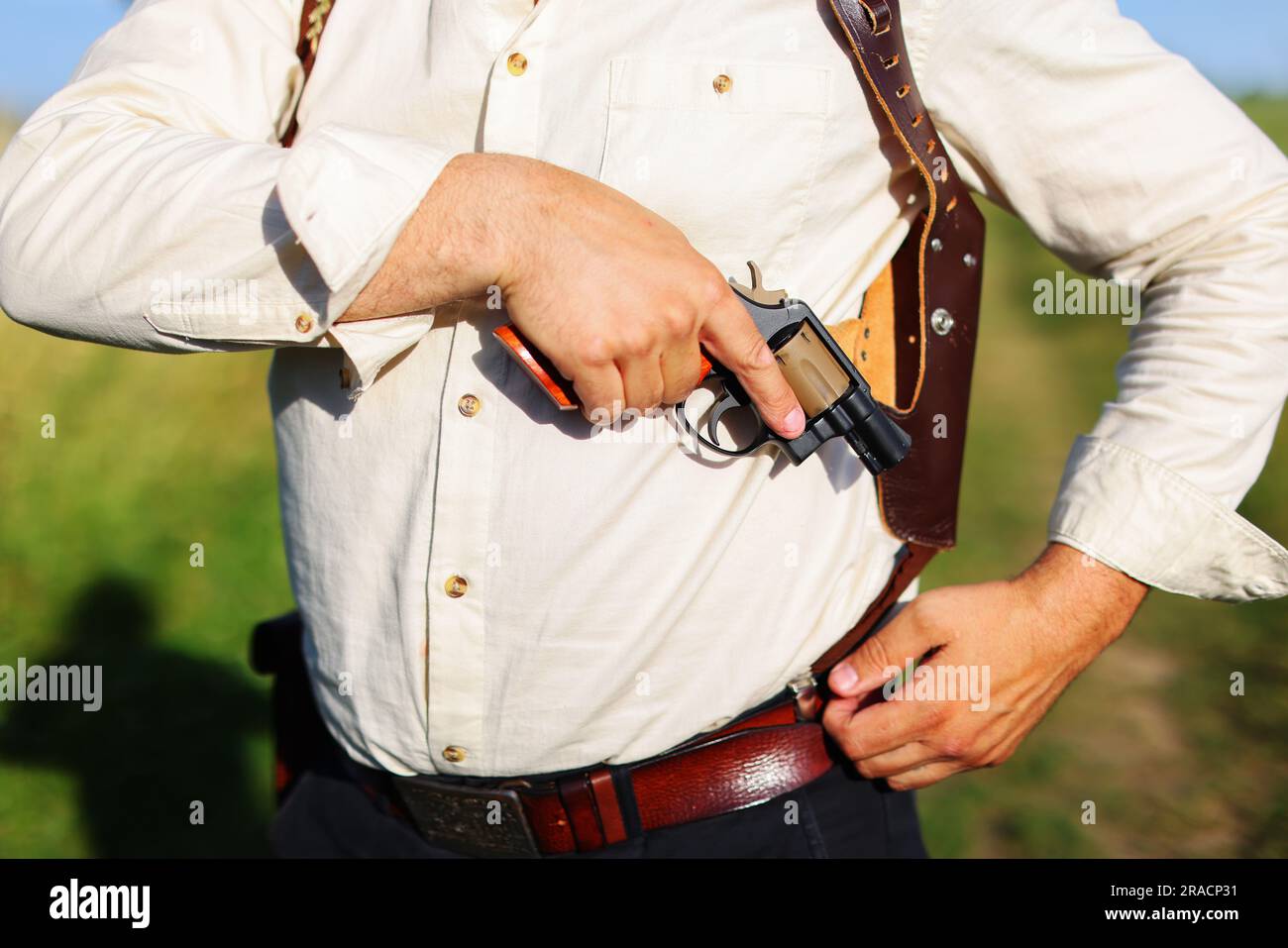 criminal police detective man holding revolver gun Stock Photo - Alamy