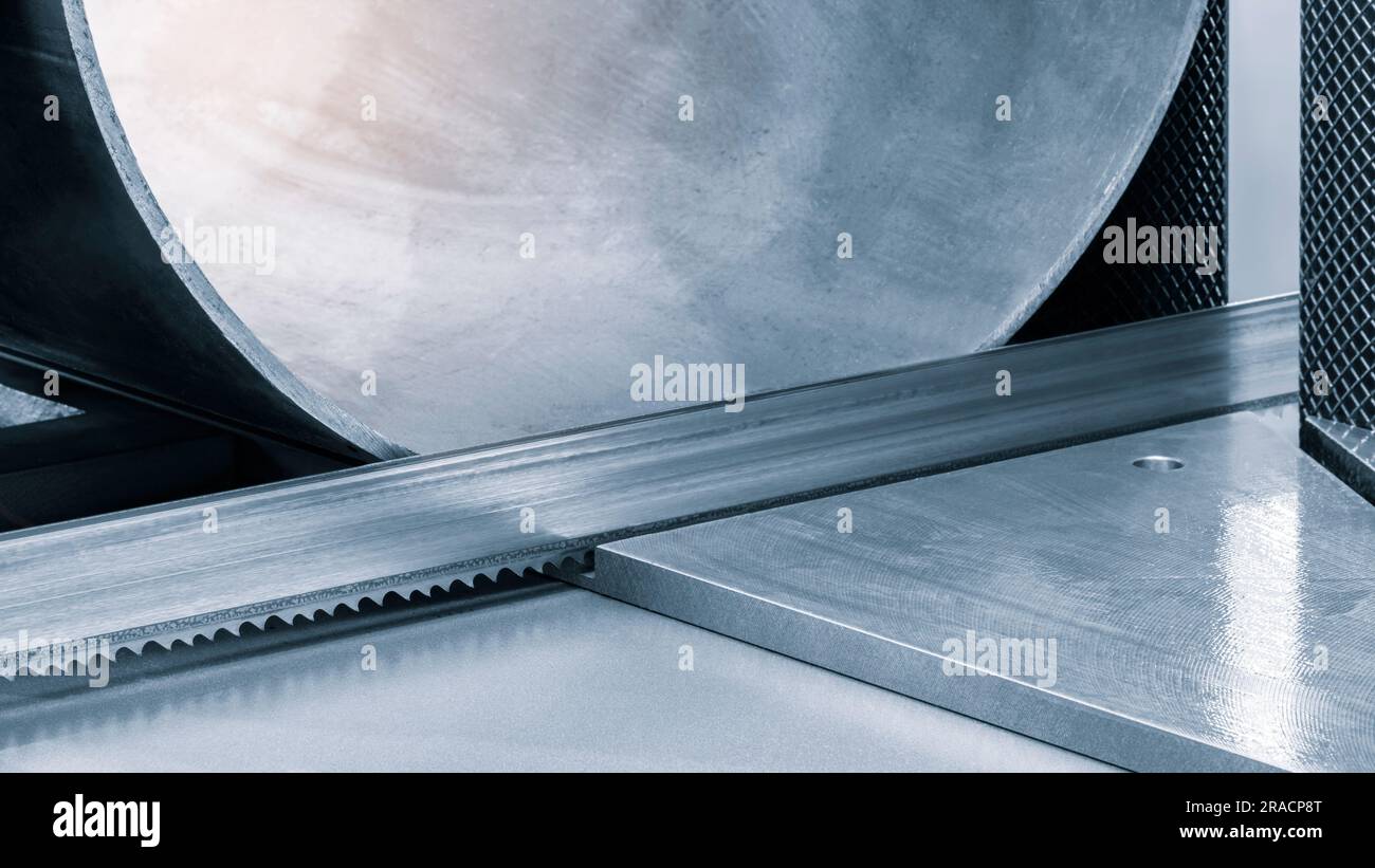 automatic band saw with coolant liquid cuts the metal rods of the ...