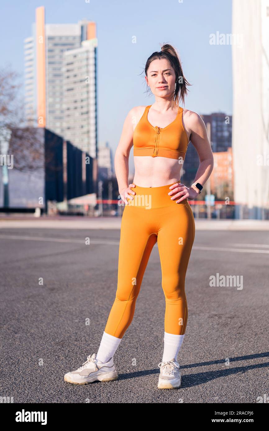female runner standing with hands on hips Stock Photo - Alamy