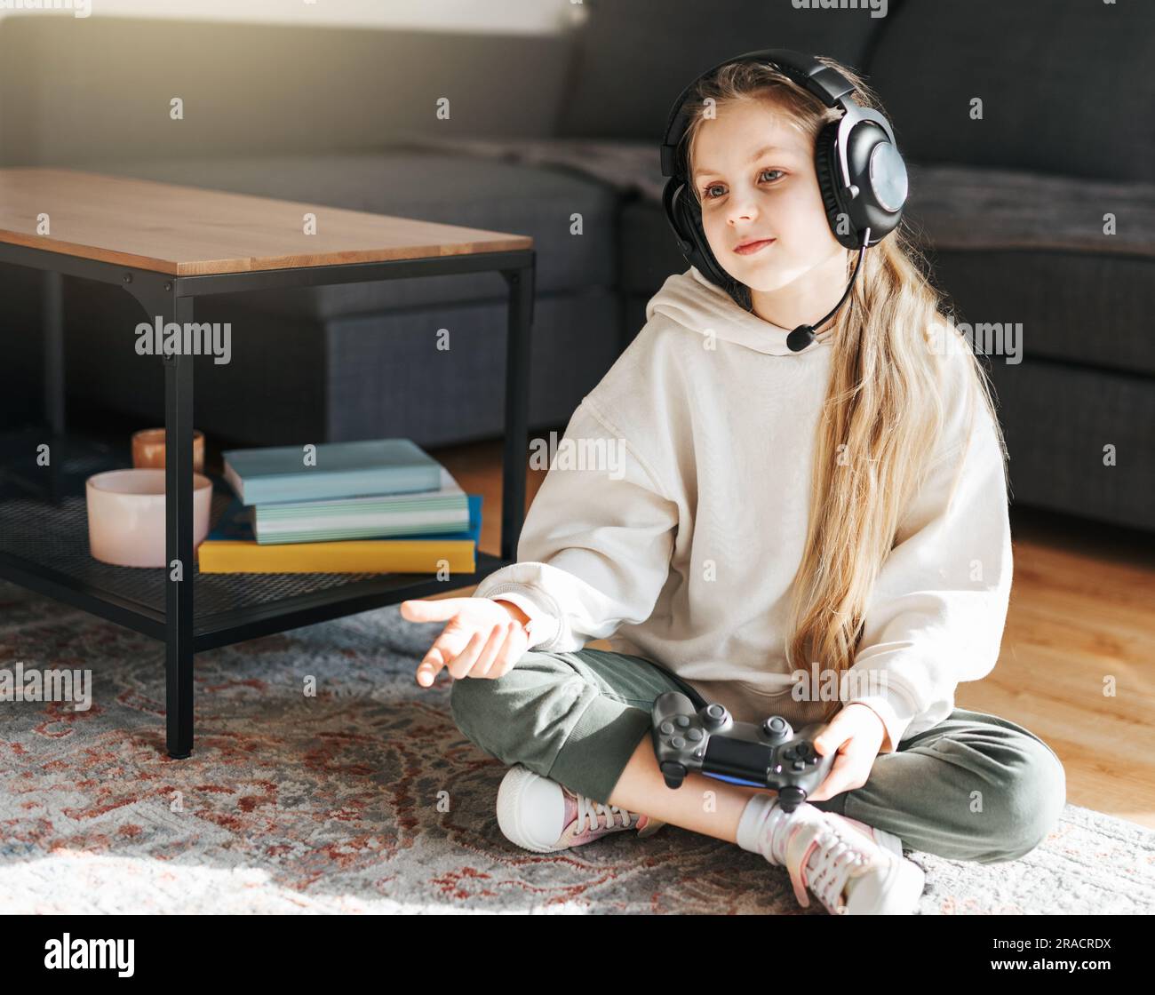 A little girl holding game controller playing video games Stock Photo ...