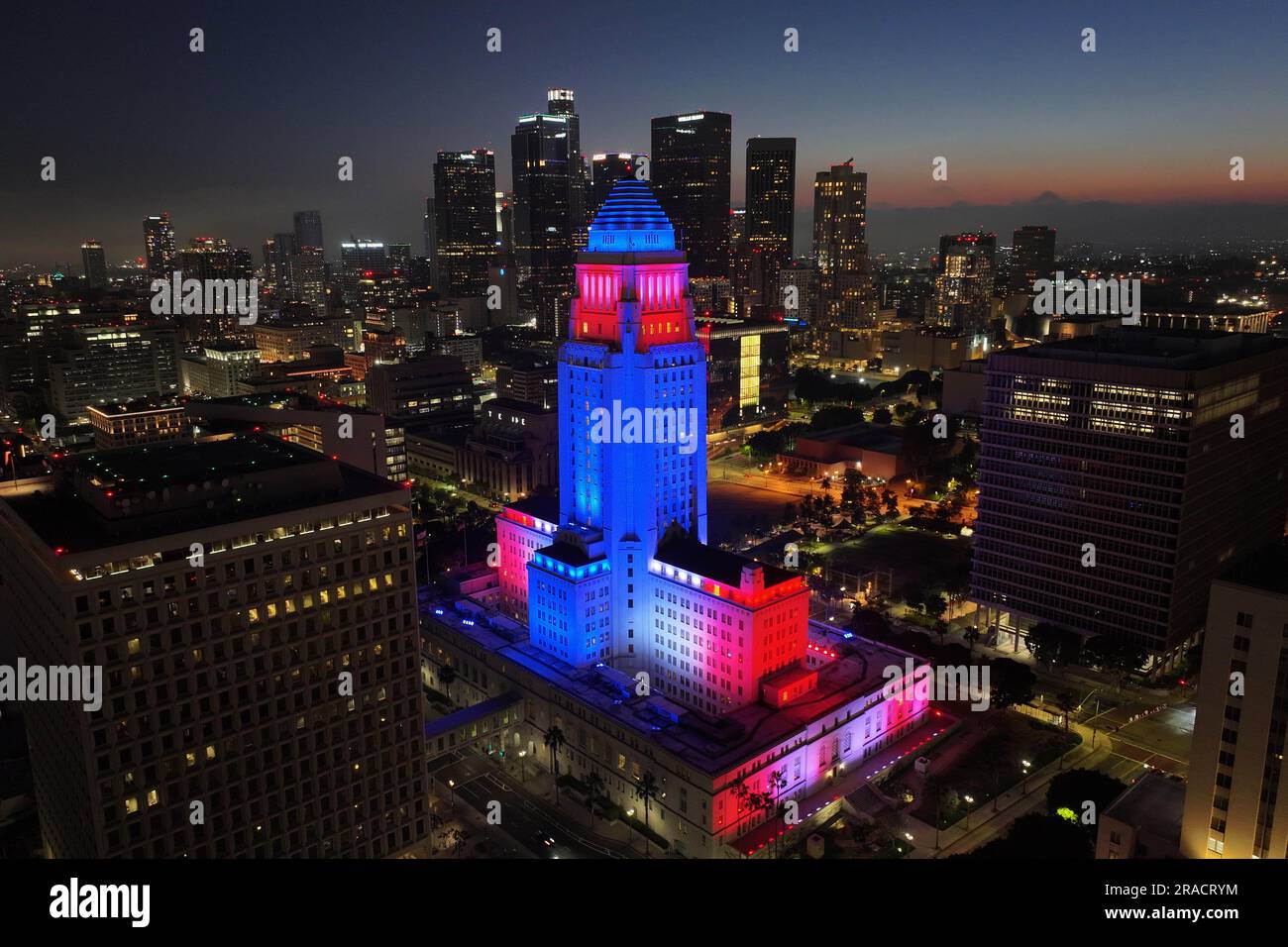 A general overall aerial view of City Hall illuminated in red, white ...