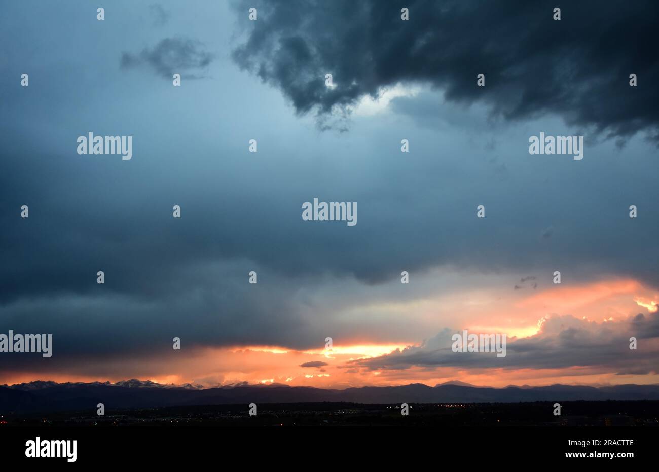 colorful sunset and storm clouds over the front range of the rocky ...