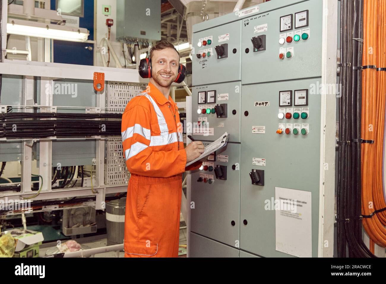 Young oil and gas professional engineer checking parameters of high ...
