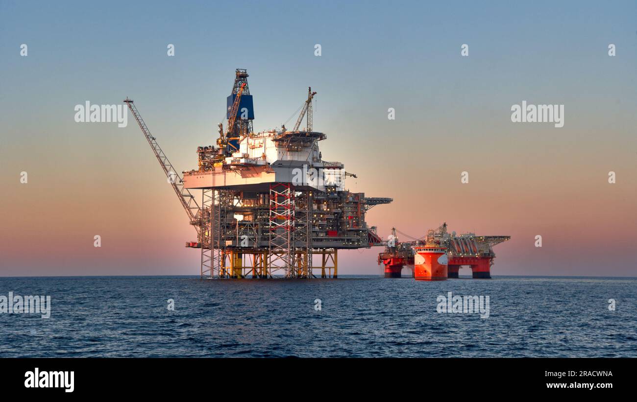 Jack up oil rig and semi submersible platform, during cargo operations ...