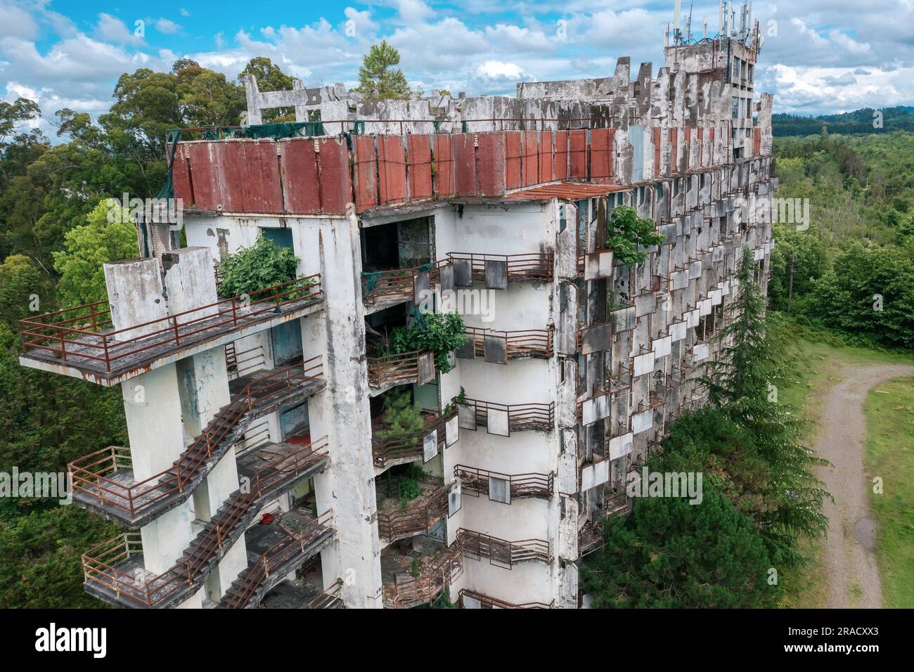 Large abandoned building overgrown with grass and plants. Urbex Lost ...