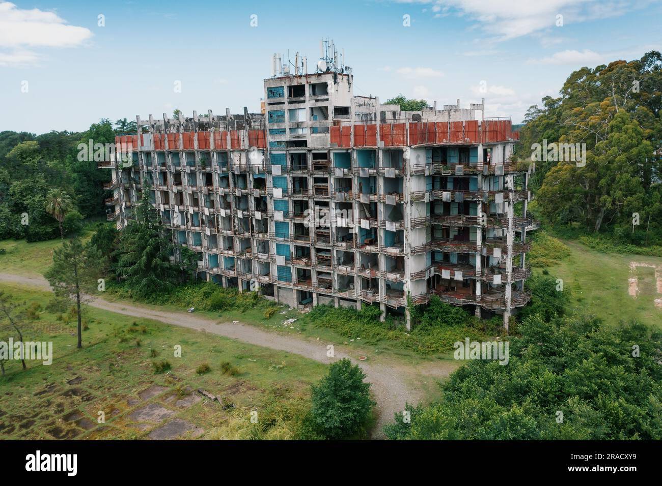 Large abandoned building overgrown with grass and plants. Urbex Lost ...