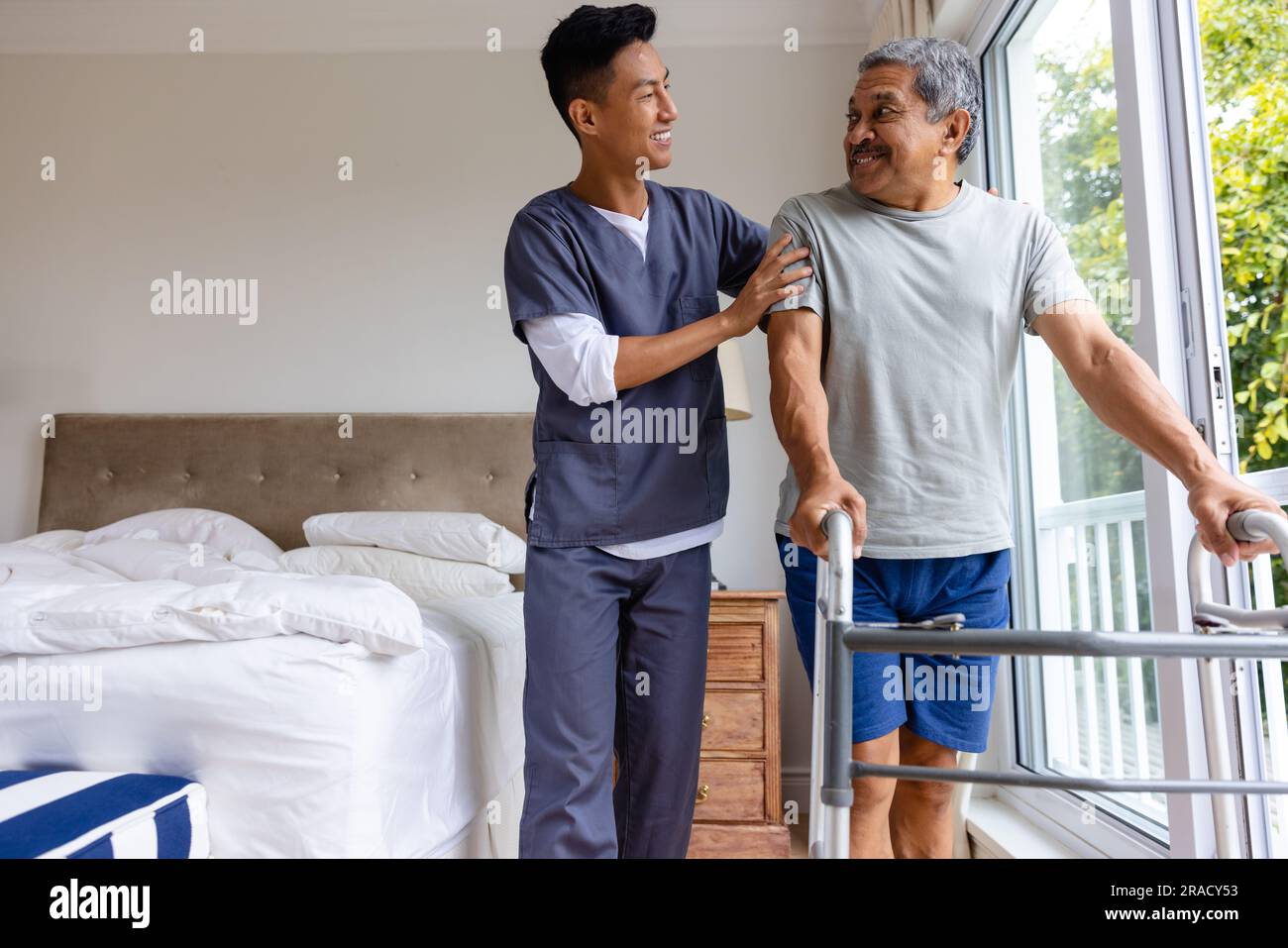 Happy diverse male doctor advising and senior male patient using ...