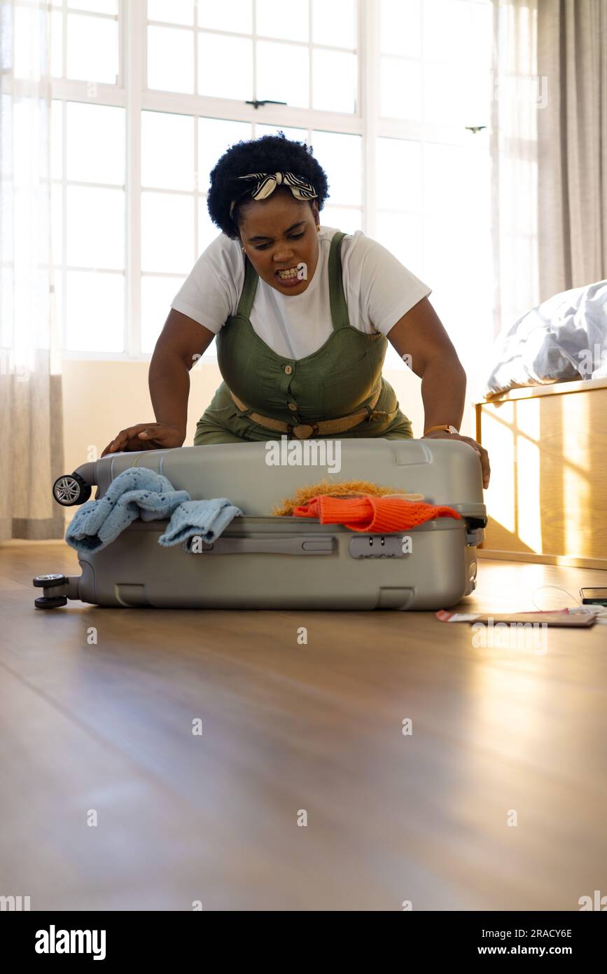 African woman packing suitcase hi-res stock photography and images - Alamy
