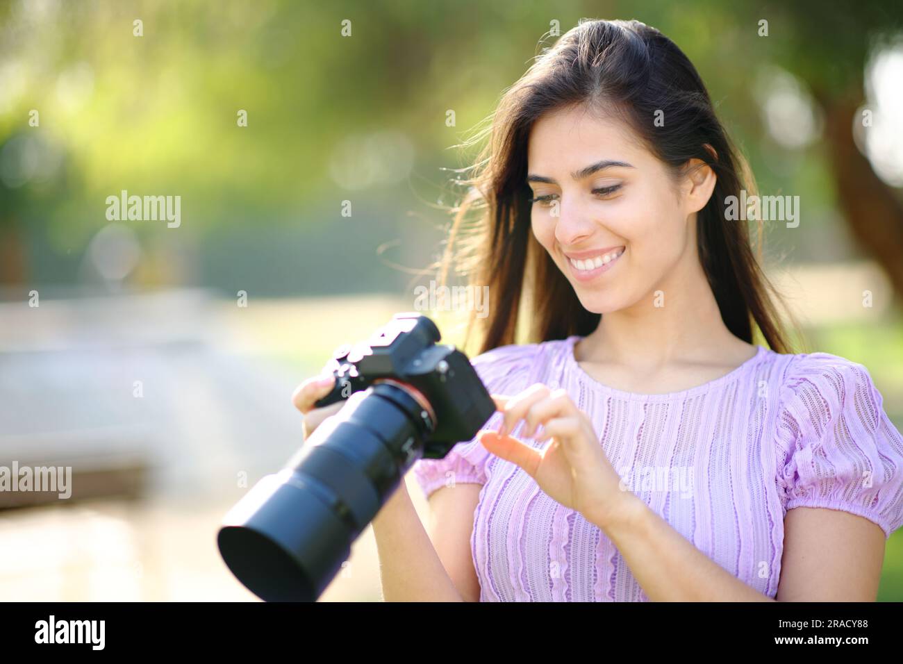 Happy photographer checking photoshoot result on mirrorless ...
