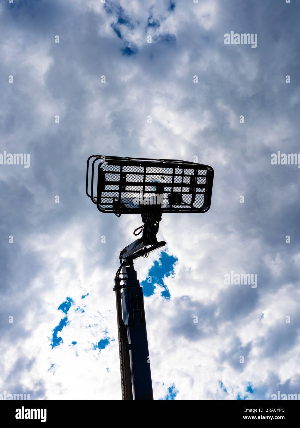 A cherry picker (an aerial work platform or bucket truck) against a ...