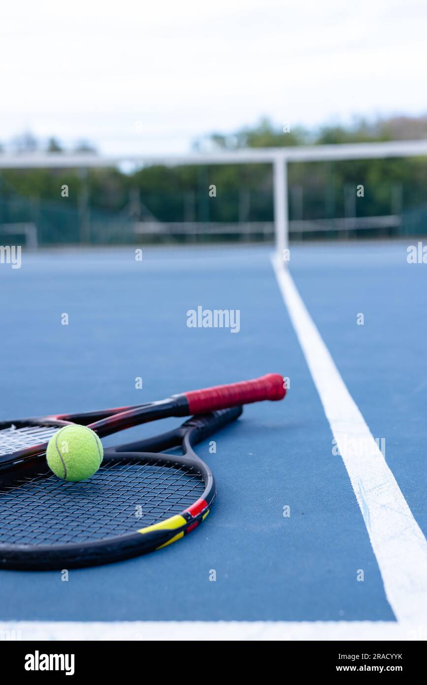 Close up of tennis ball and tennis rackets lying on outdoor tennis ...