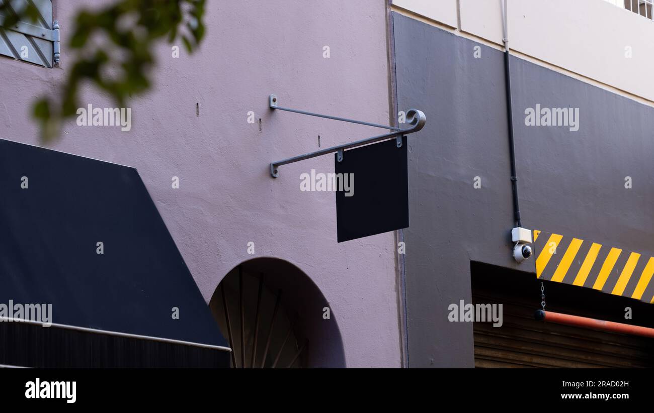 Blank sign fixed to building wall with copy space Stock Photo - Alamy