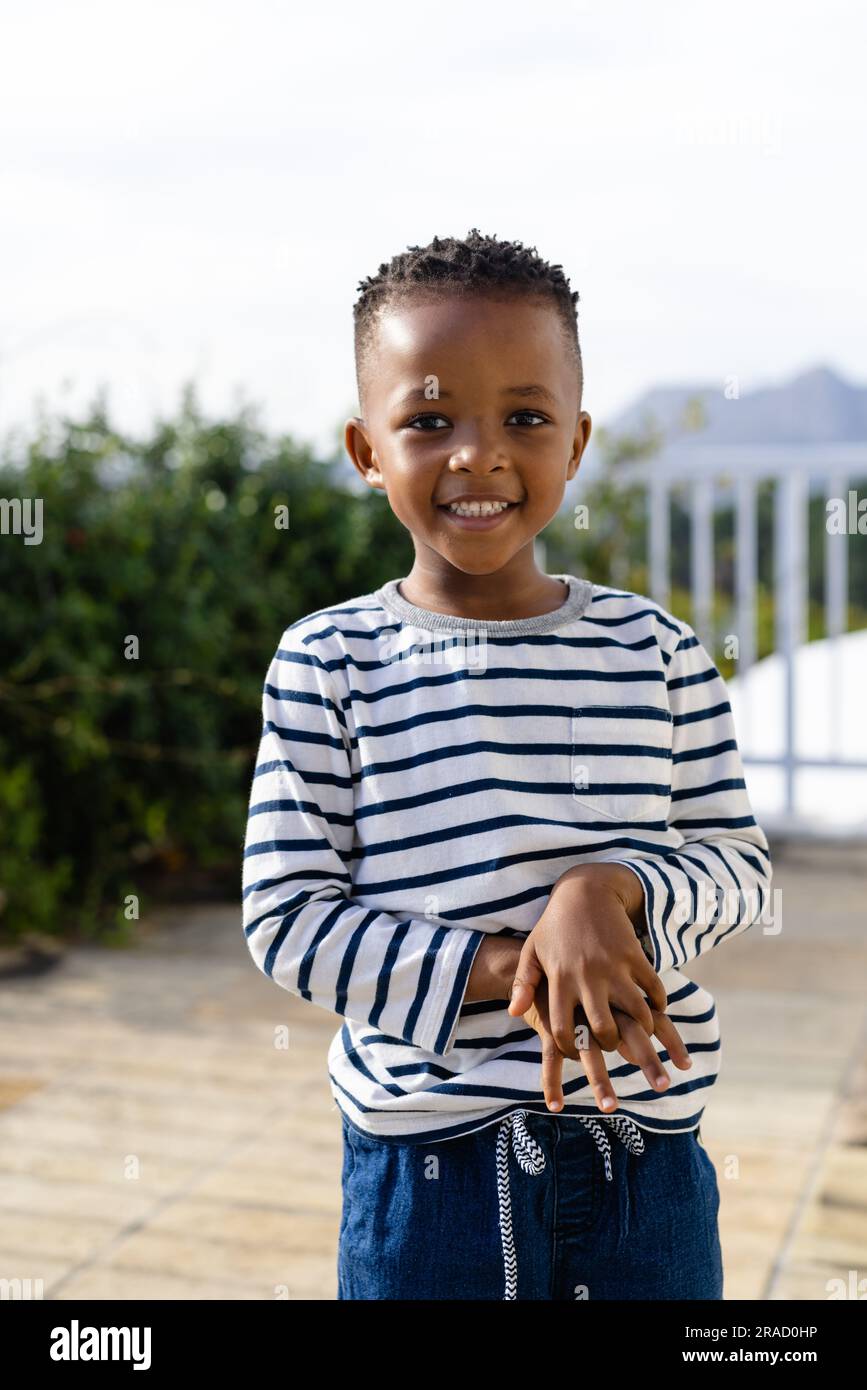 Portrait of happy african american boy staying on sunny terrace Stock ...