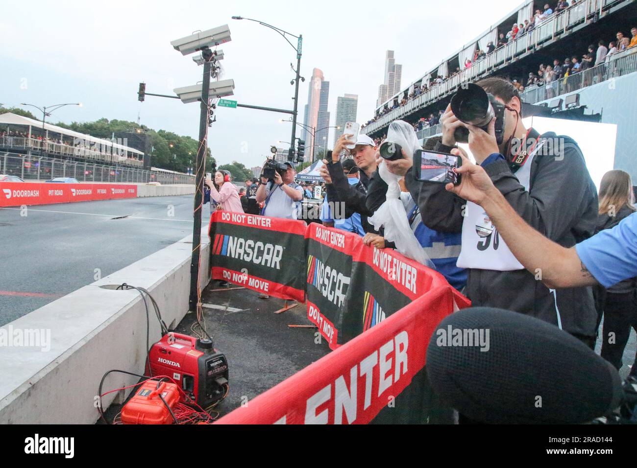 Media and VIP guests watch the 2-lap overtime to determine the winner ...