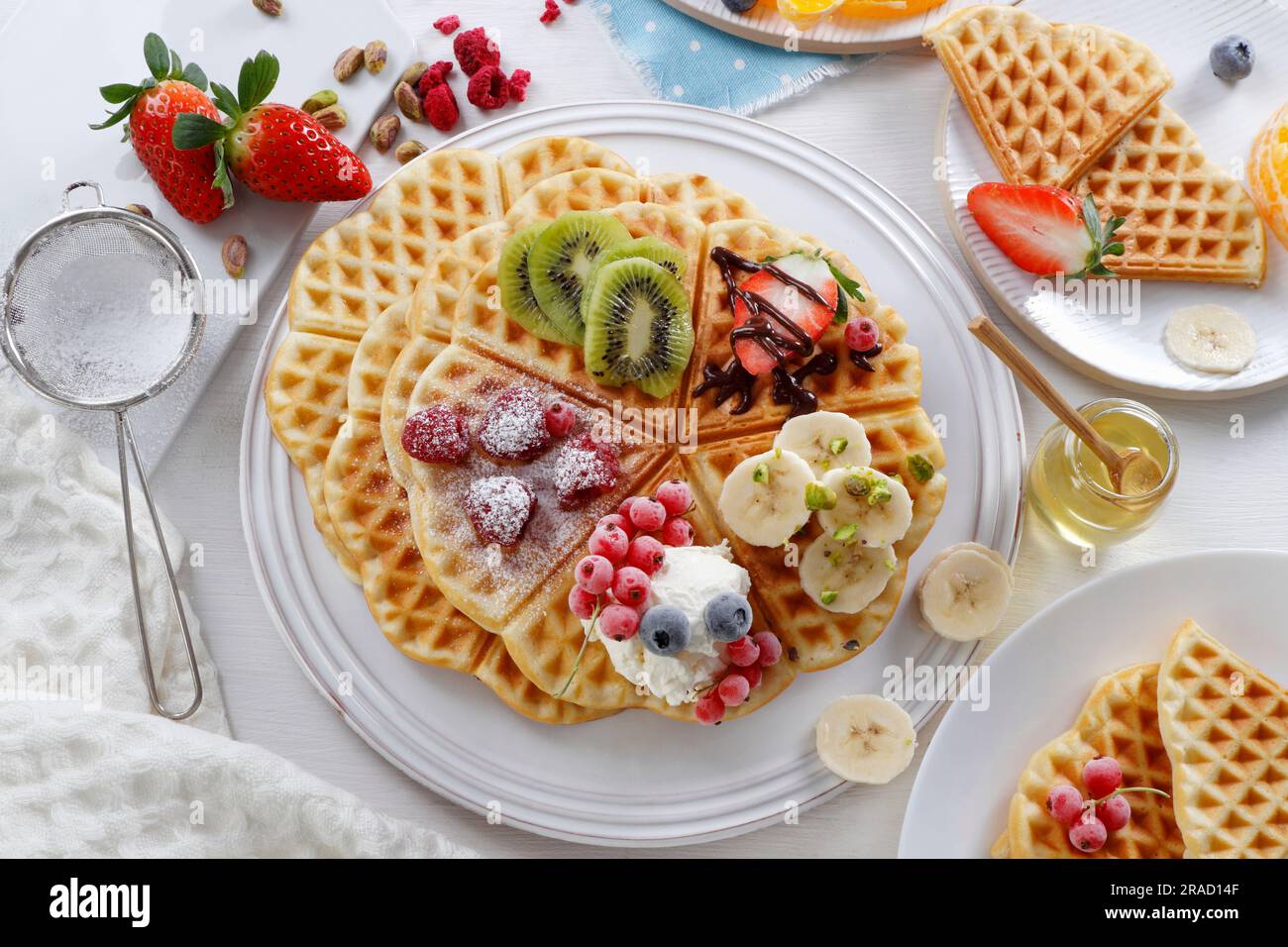 Heart-shaped waffles with various toppings Stock Photo - Alamy
