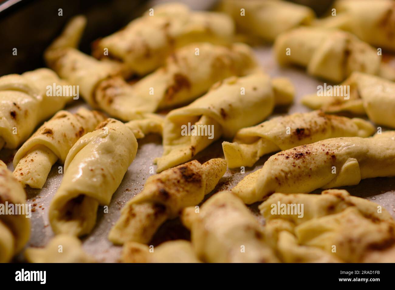 Preparing mini croissants and placing them on a baking sheet for ...
