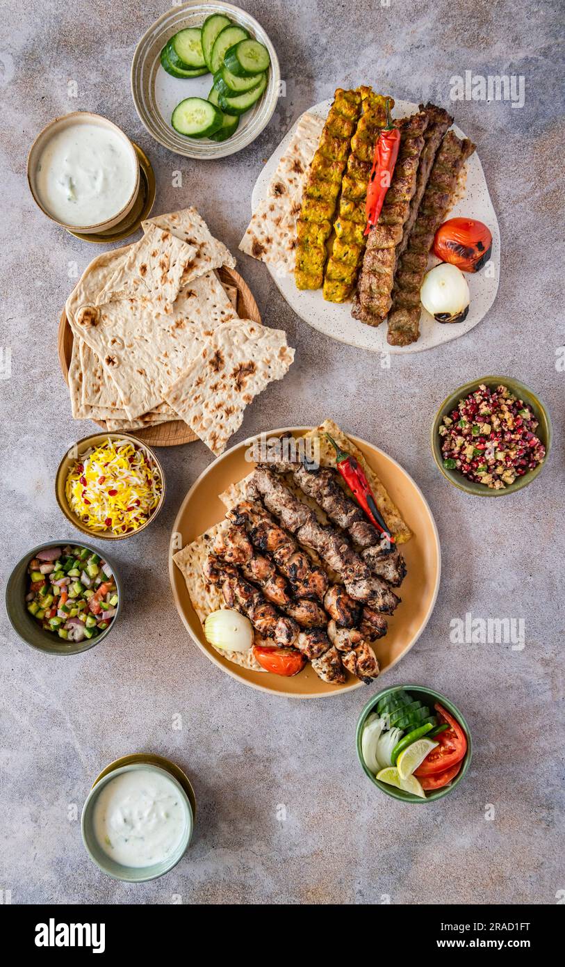 Kabab Koobideh (Iranian barbecue skewers) with salads, rice and Tanoor ...