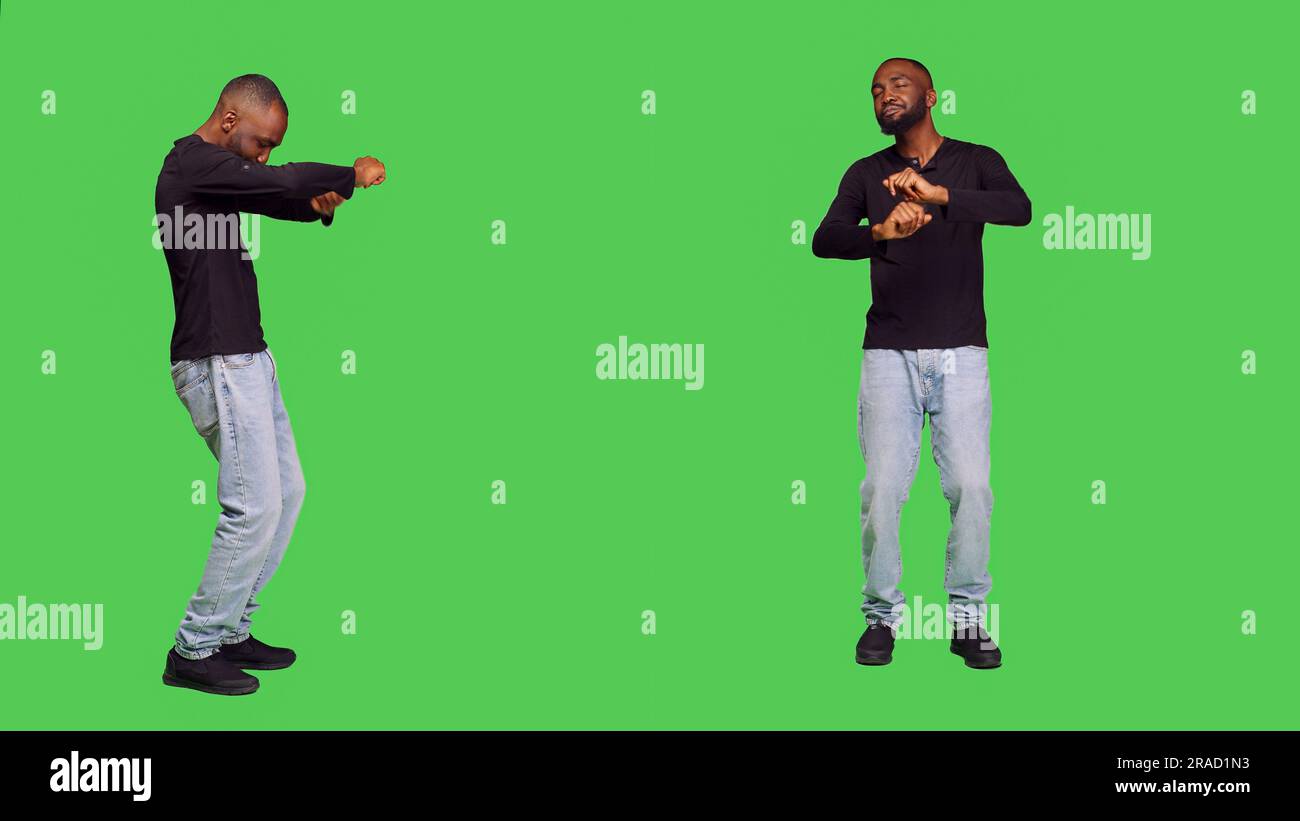 Cheerful model showing dance moves and acting silly standing over full ...