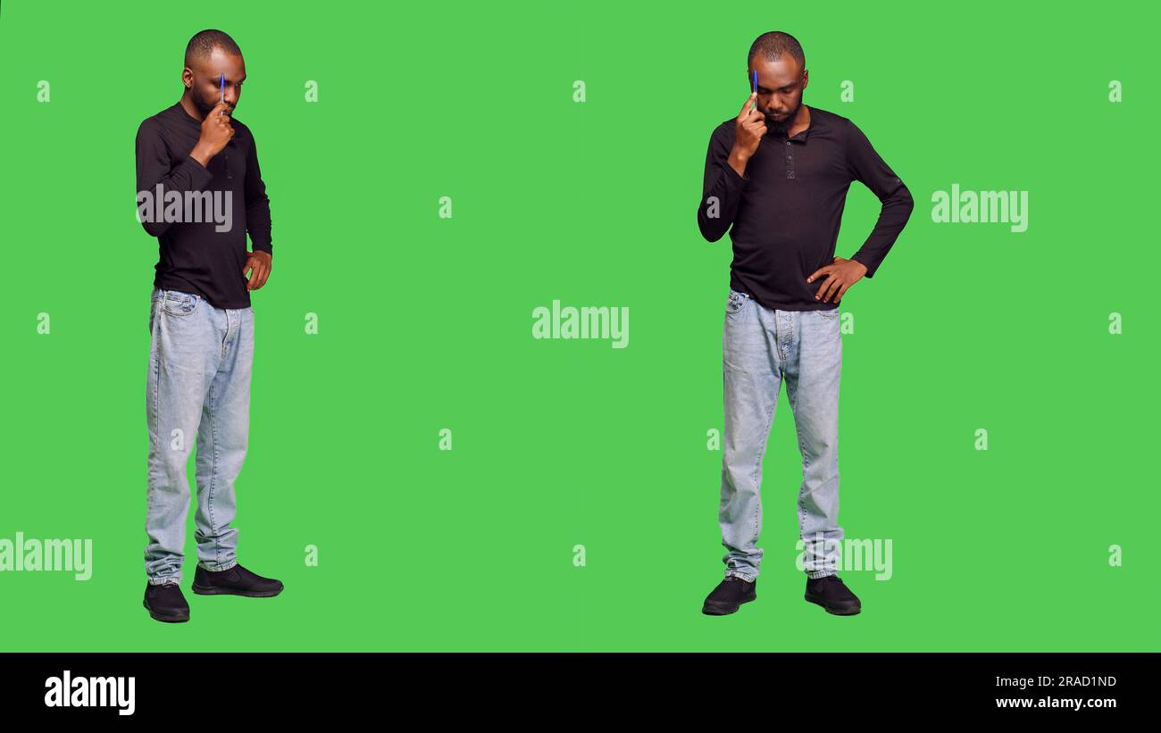 Pensive young man thinking about right decision in studio, feeling ...