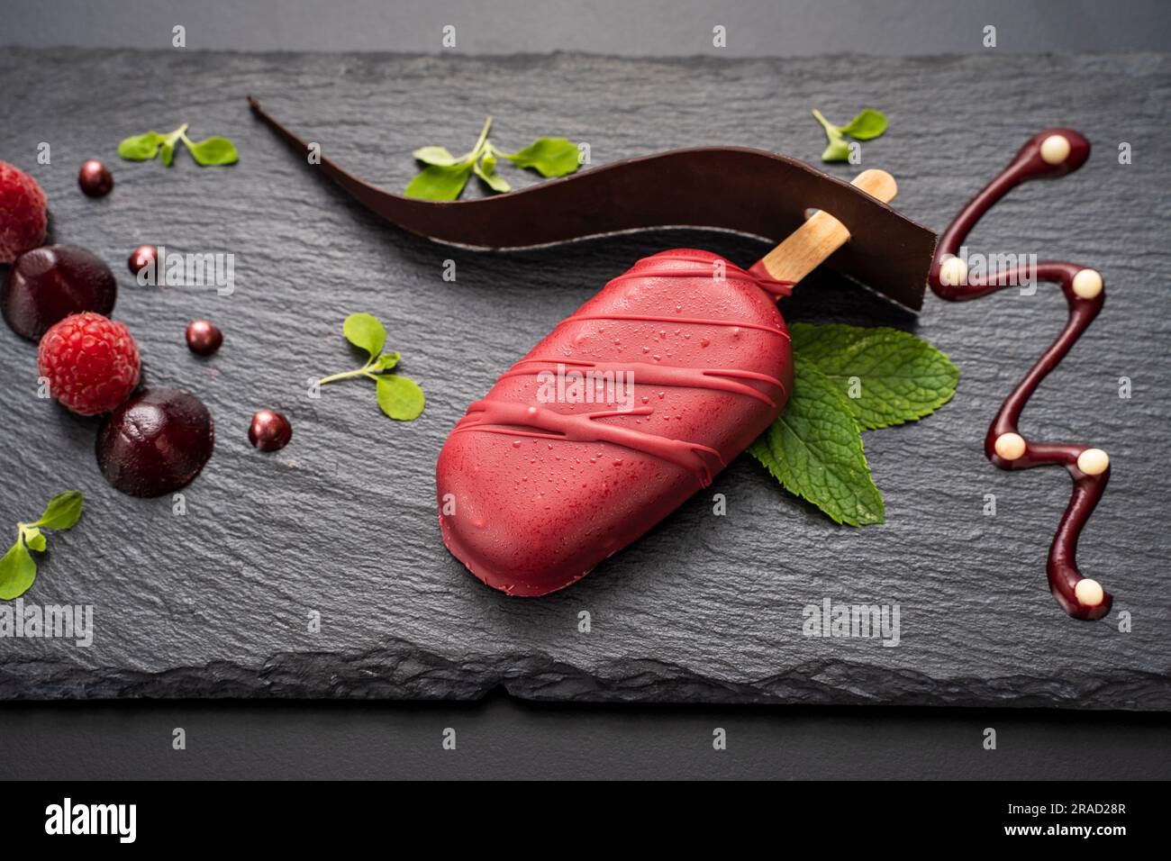 Raspberry ice cream on a stick Stock Photo - Alamy