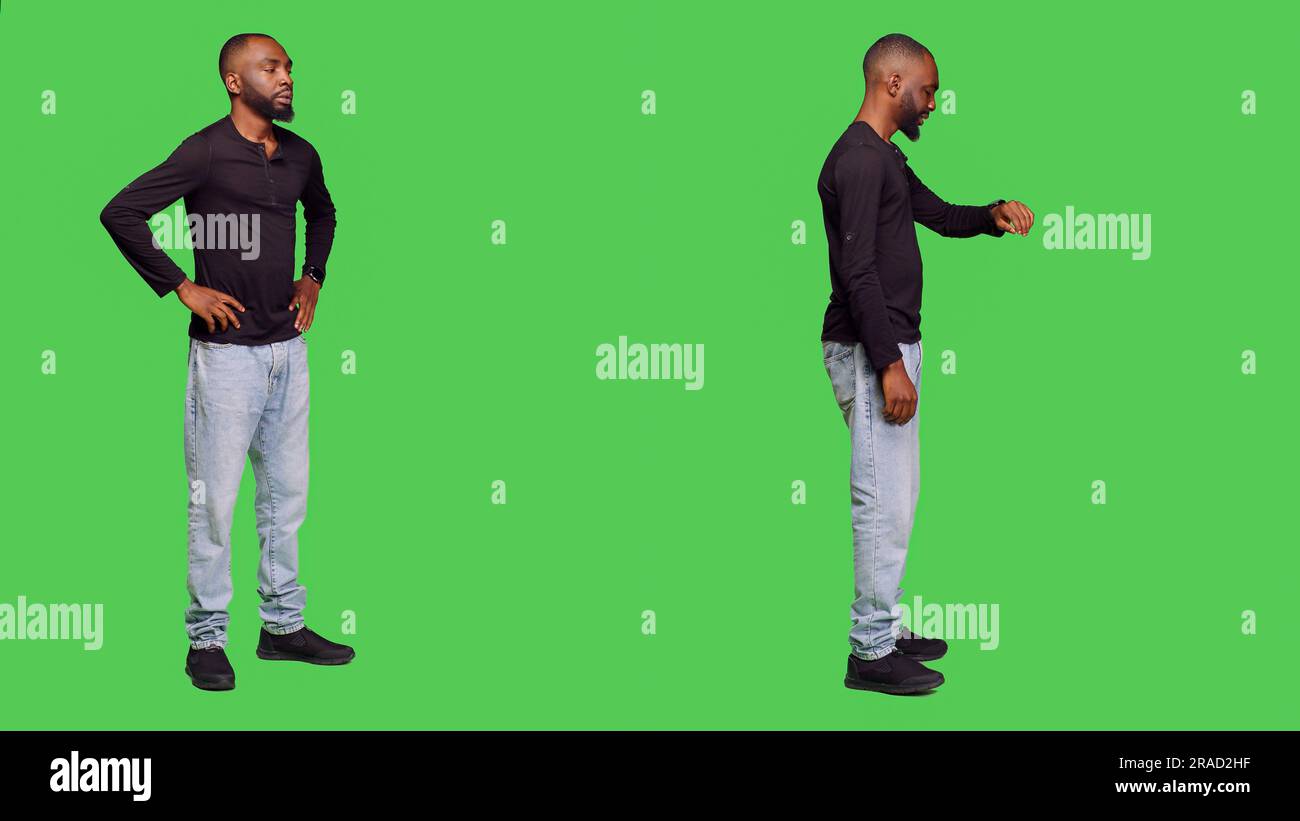 Casual adult looking at time on wristwatch in studio, checking hour ...