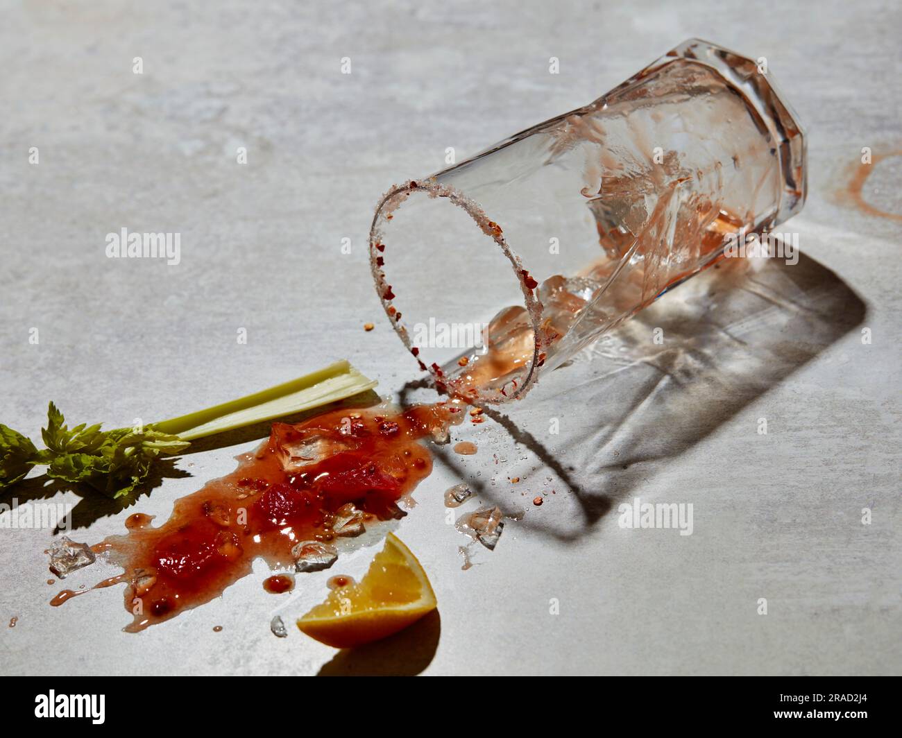 Tipped over glass with remains of Bloody Mary Stock Photo - Alamy