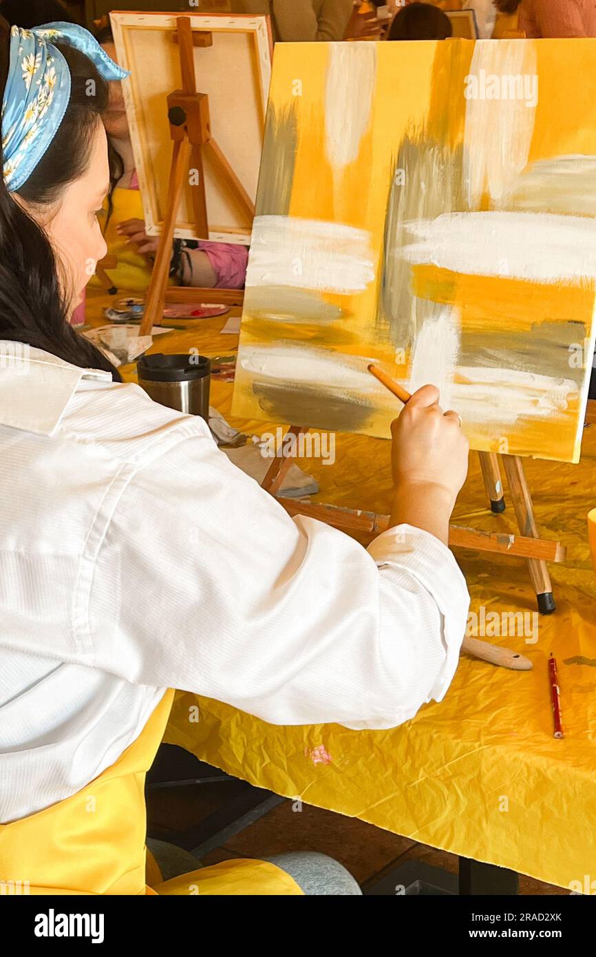 Woman paint brush canvas friends hi-res stock photography and images ...