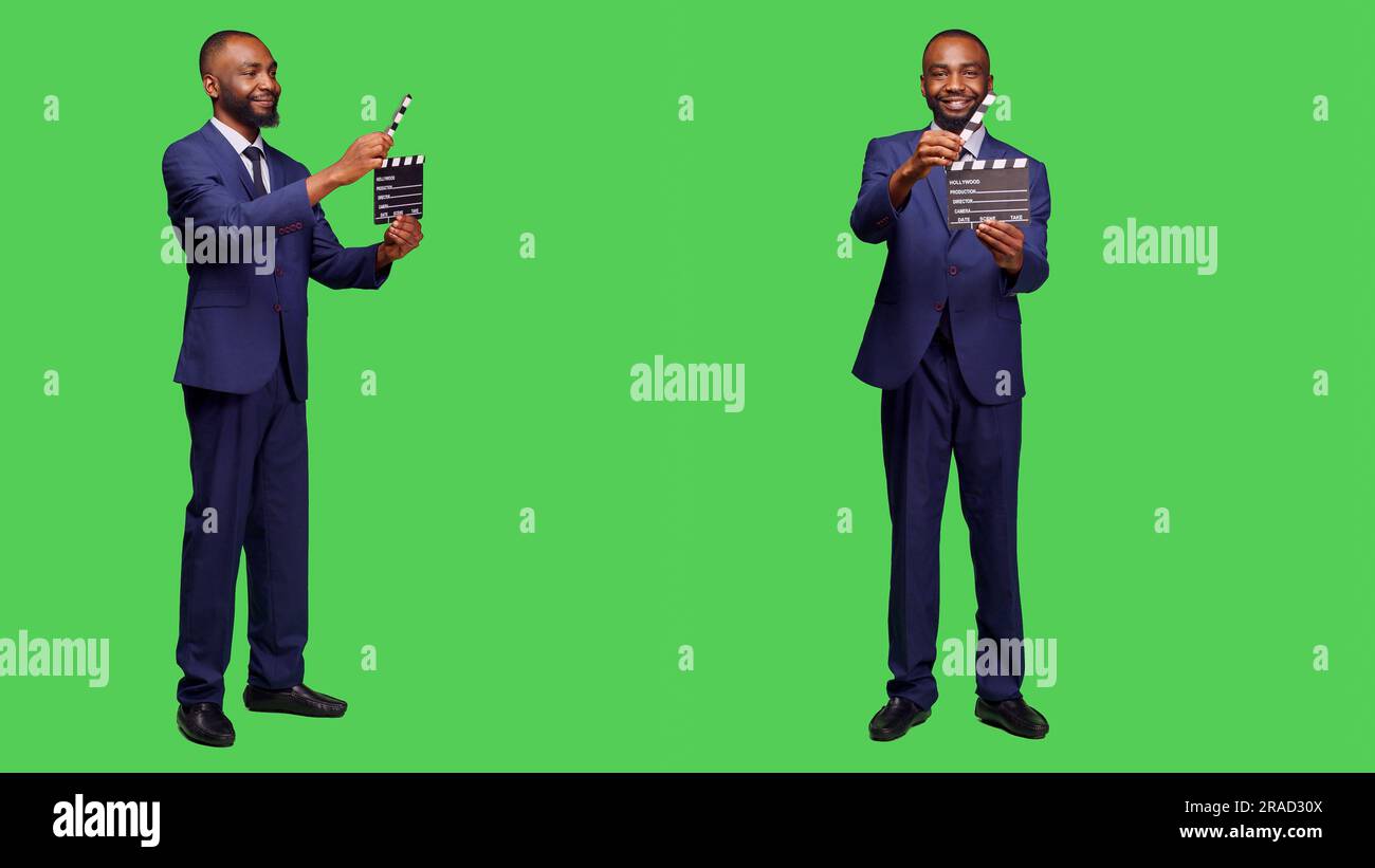 Businessman filmmaker holding flapperboard in studio, working in movie ...