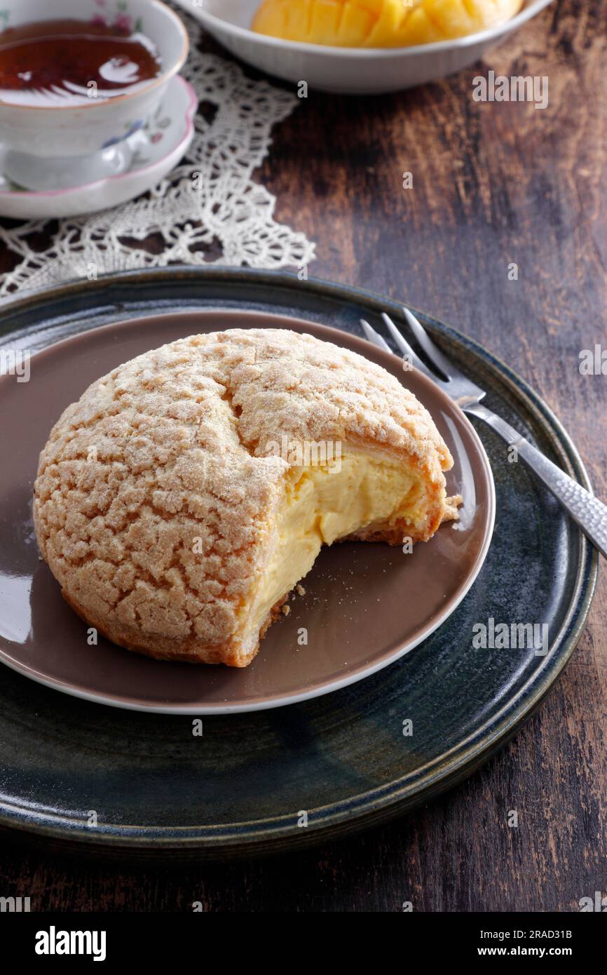 Choux craquelin with mango cream filling Stock Photo - Alamy