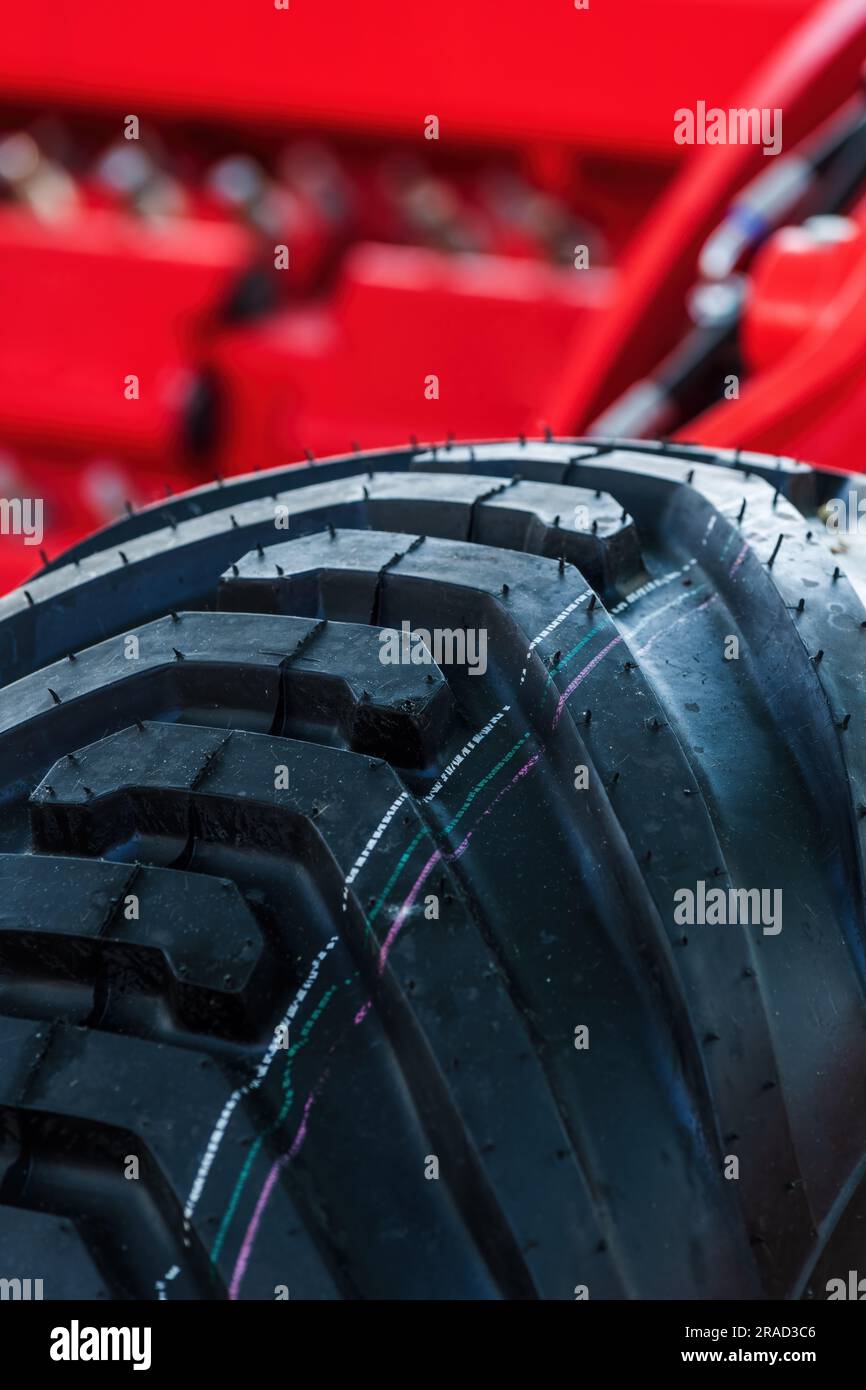 Brand new unused tractor tire with with lug tread, selective focus ...