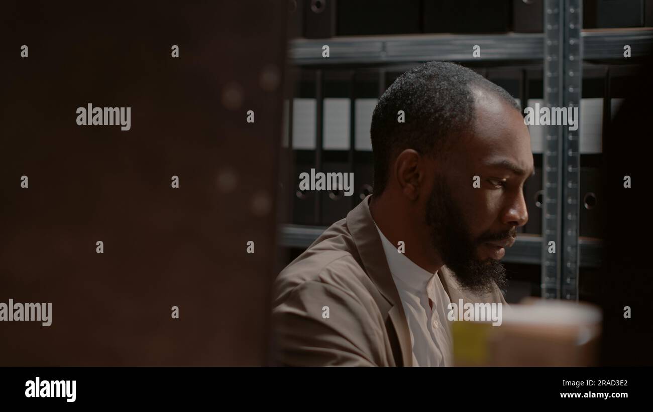 African american detective conducting investigation with laptop ...