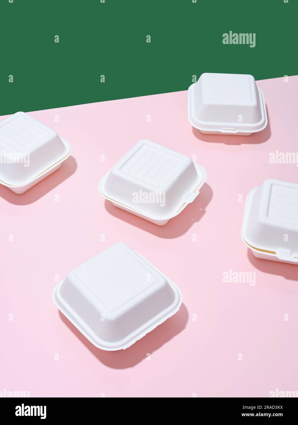Take-out boxes for burgers against a green and pink background Stock ...