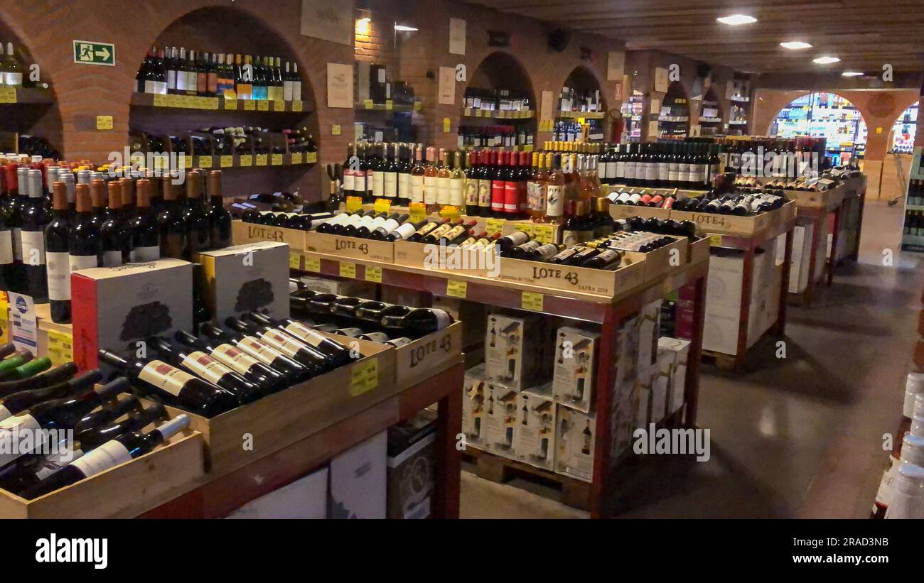 bottles with blank labels on the counter of a liquor store. Wine ...
