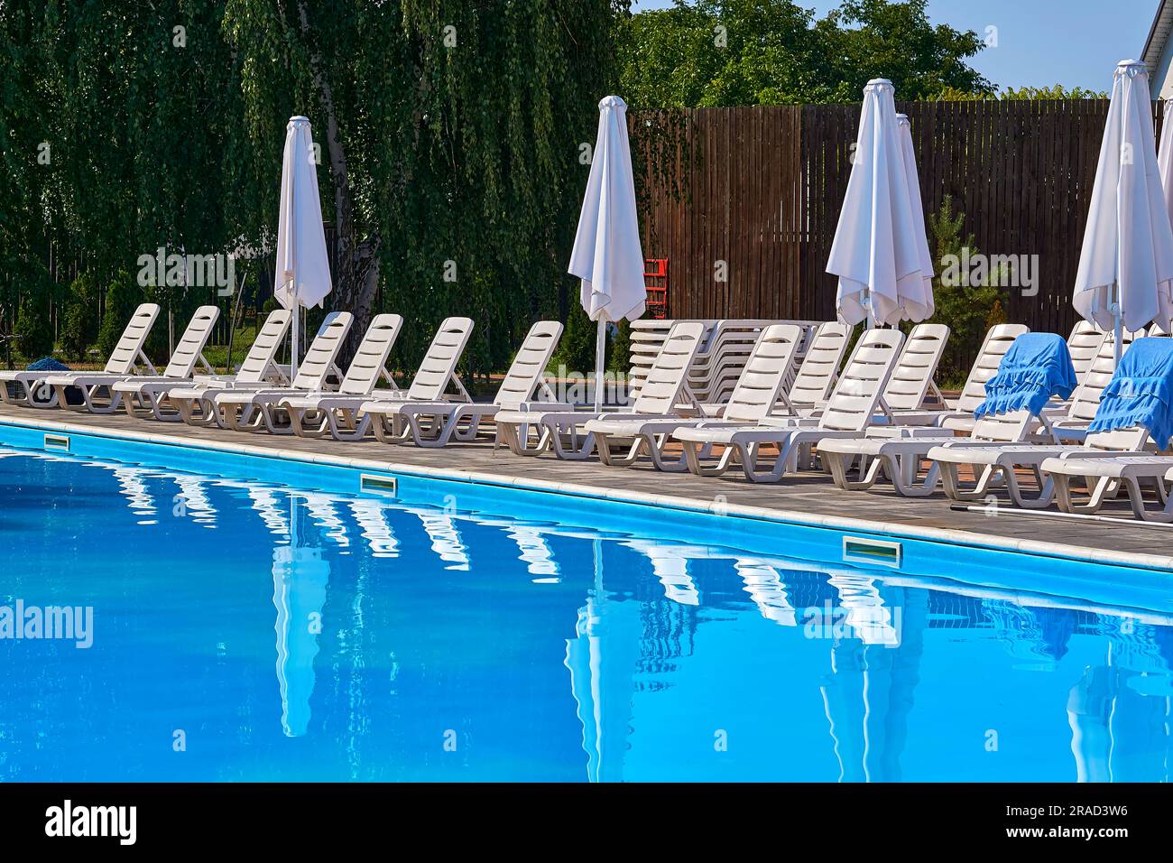 Summer outdoor pool at the resort with sun loungers waiting for people ...