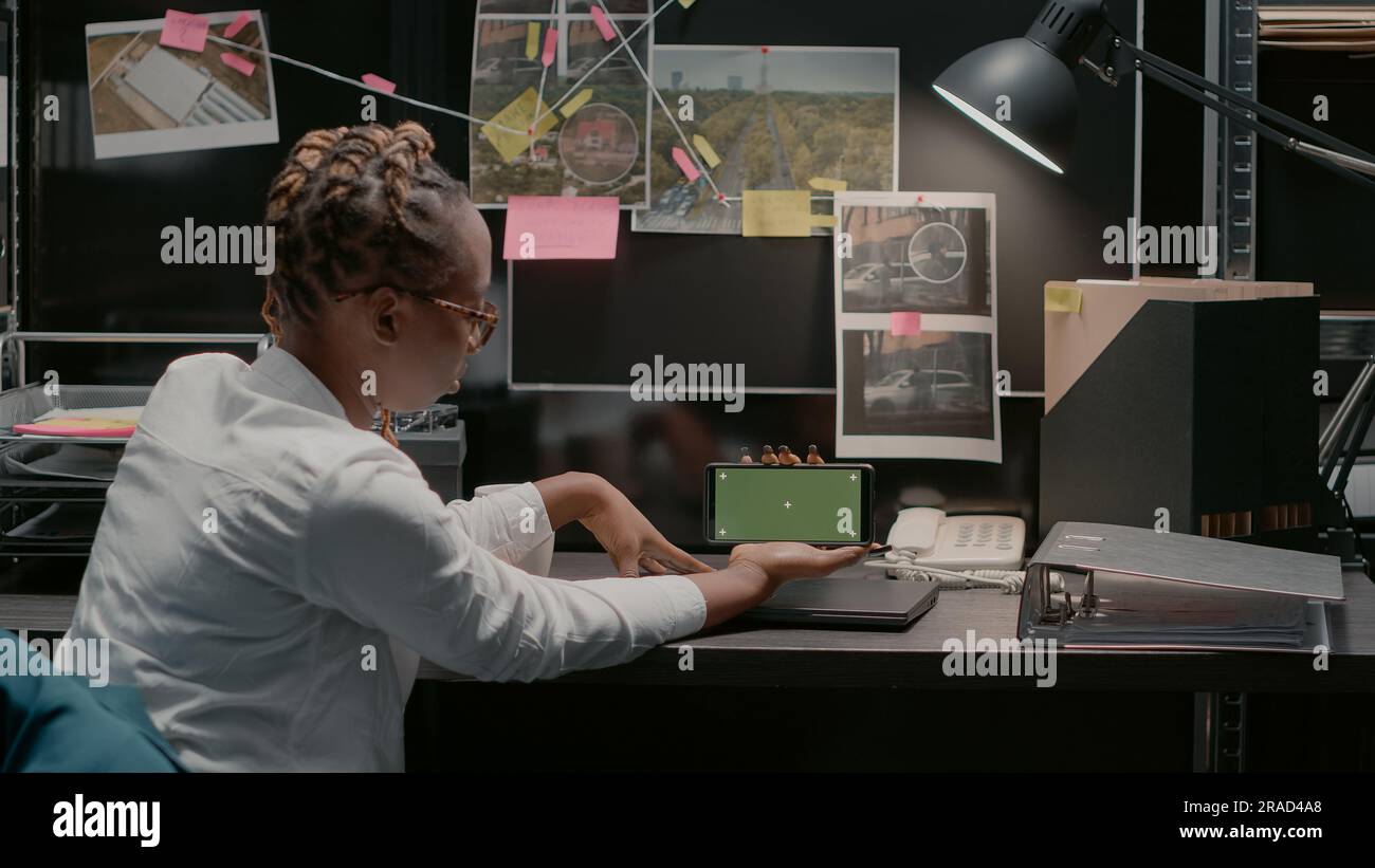 Young inspector using greenscreen in archive office space, examining ...