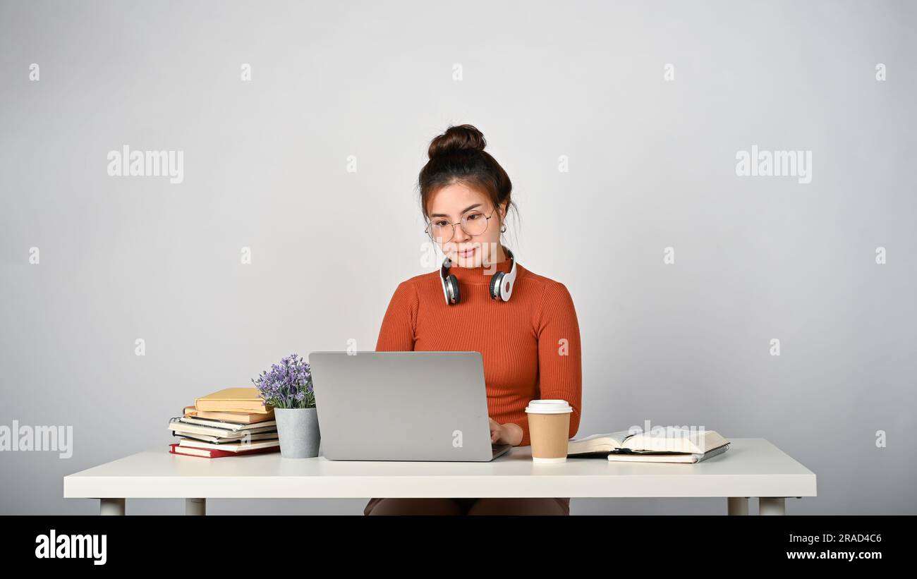 Young beautiful college student study with laptop computer, white ...